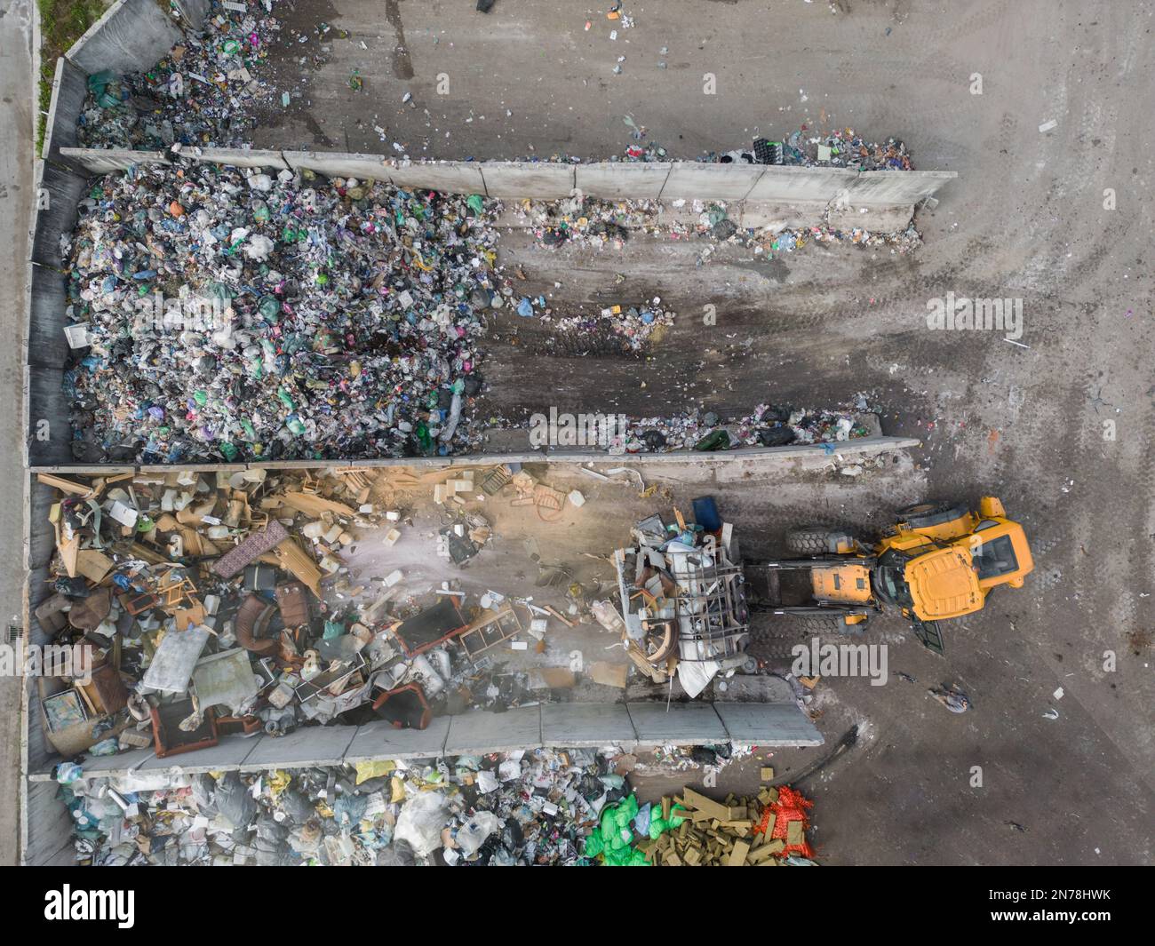 Process of moving a pile of waste with heavy equipment, wheel loader at ...