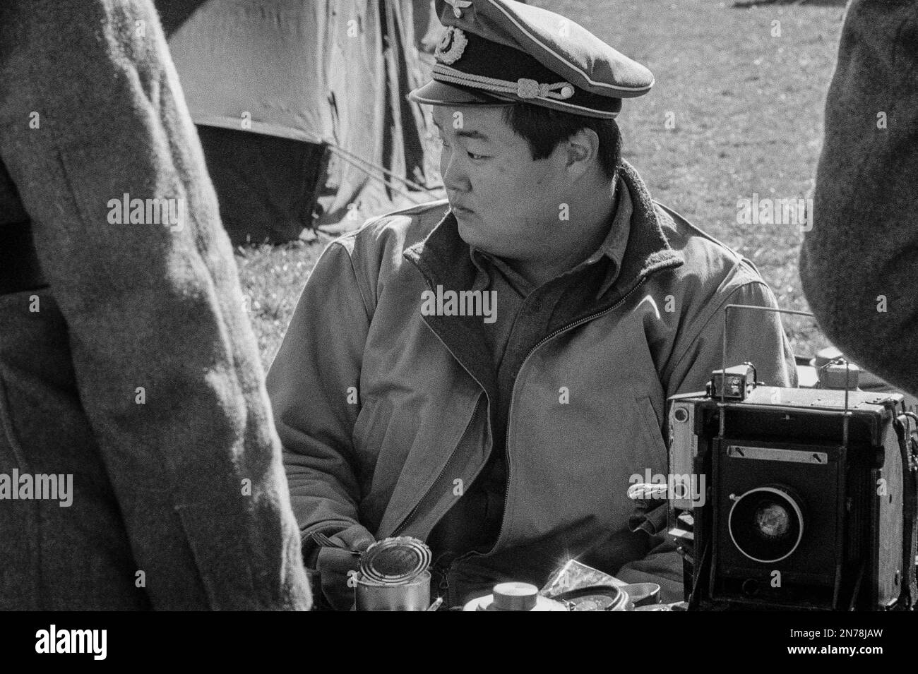 WWII German soldiers seated at a table with vintage camera equipment ...