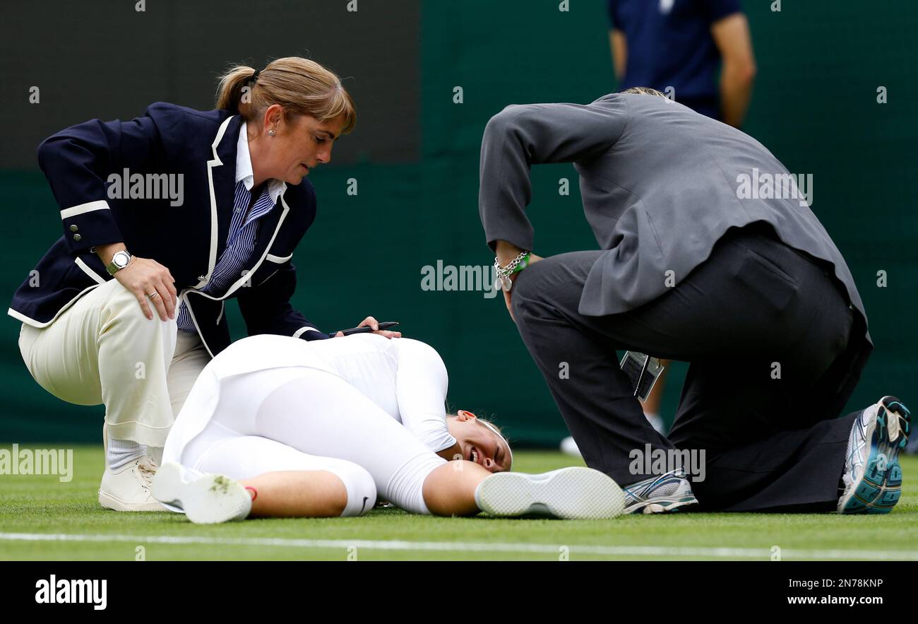 Victoria Azarenka of Belarus, center, lies on the court after taking a ...