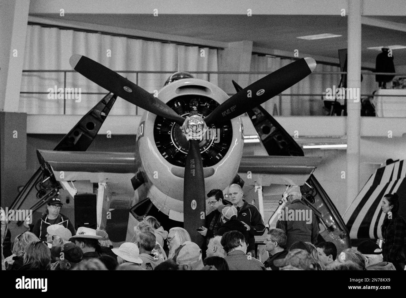 A crowd is gathered in front of North American A-6F Texan airplane in ...