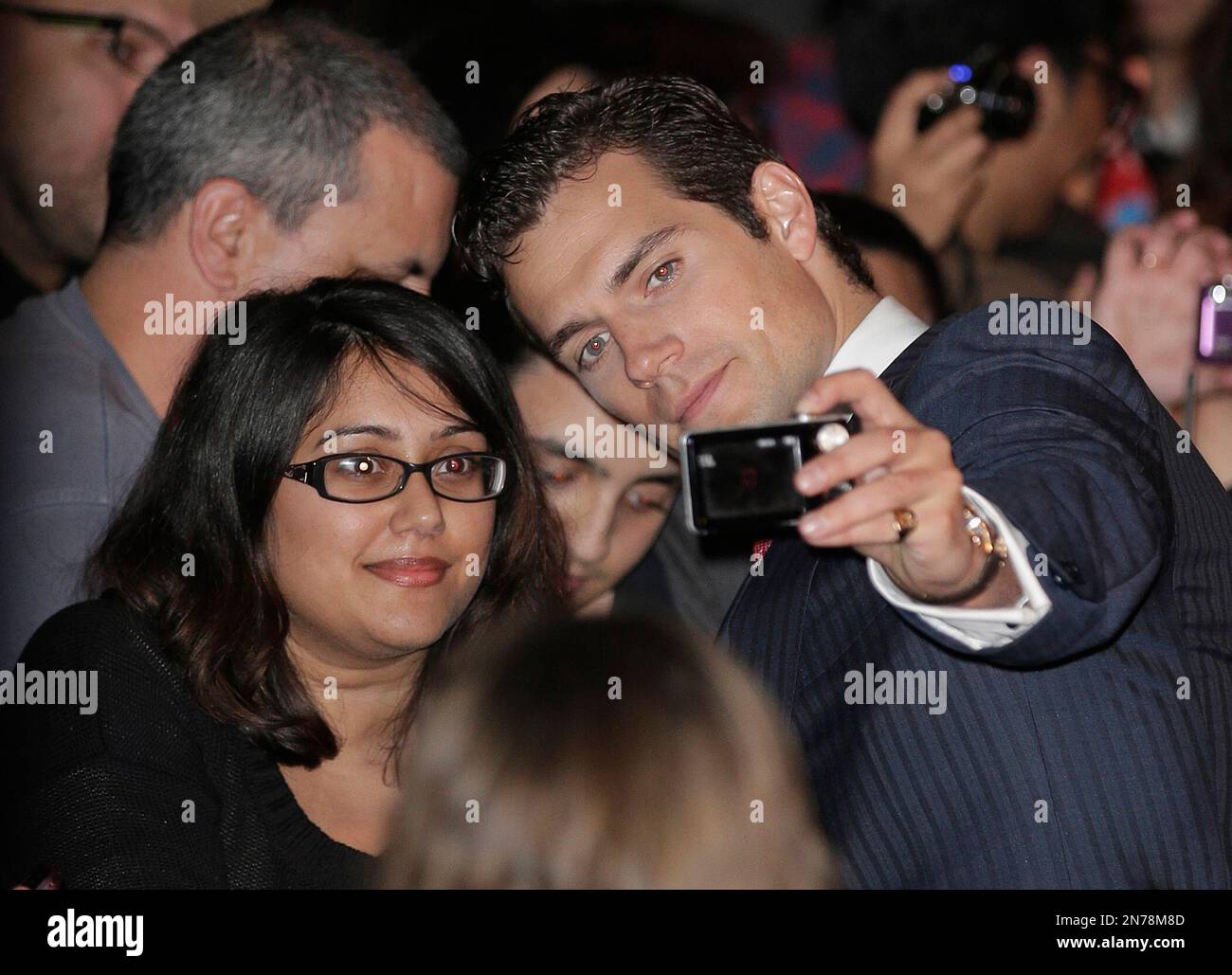 Actor Henry Cavill has his picture taken with a fan during his new ...