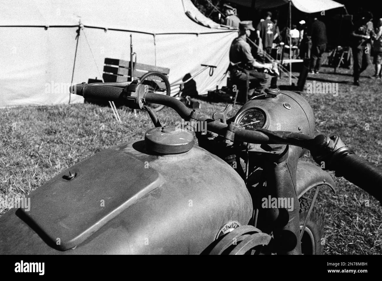 WWII BMW motorcycle parked at a camp in a field during a reenactment at ...