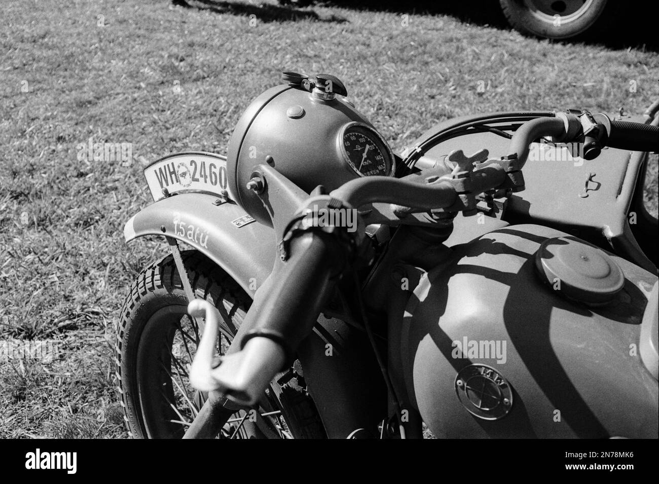 WWII BMW motorcycle parked at a camp in a field during a reenactment at ...