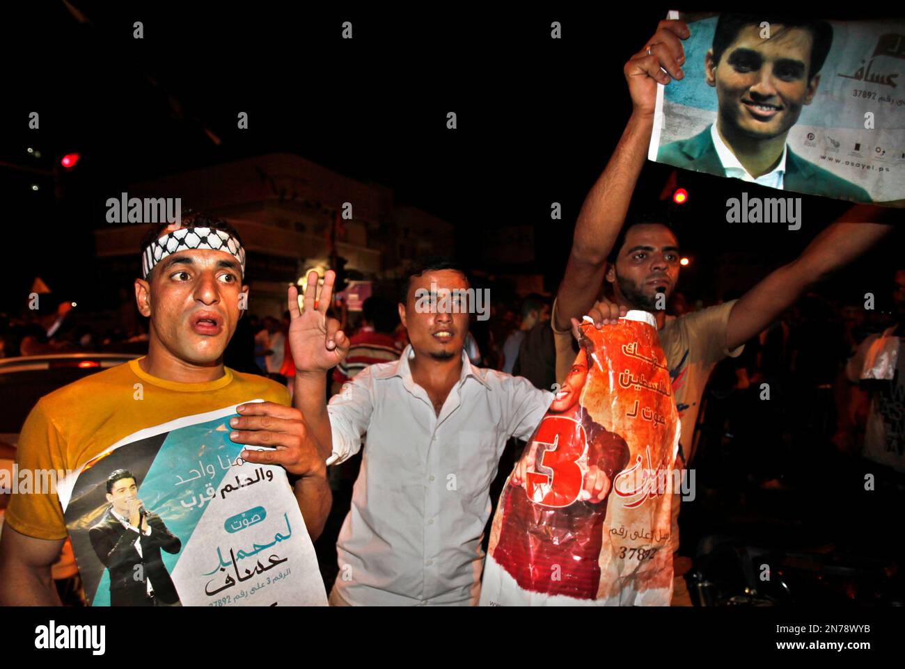 Palestinians hold pictures of Palestinian singer Mohammed Assaf as they ...