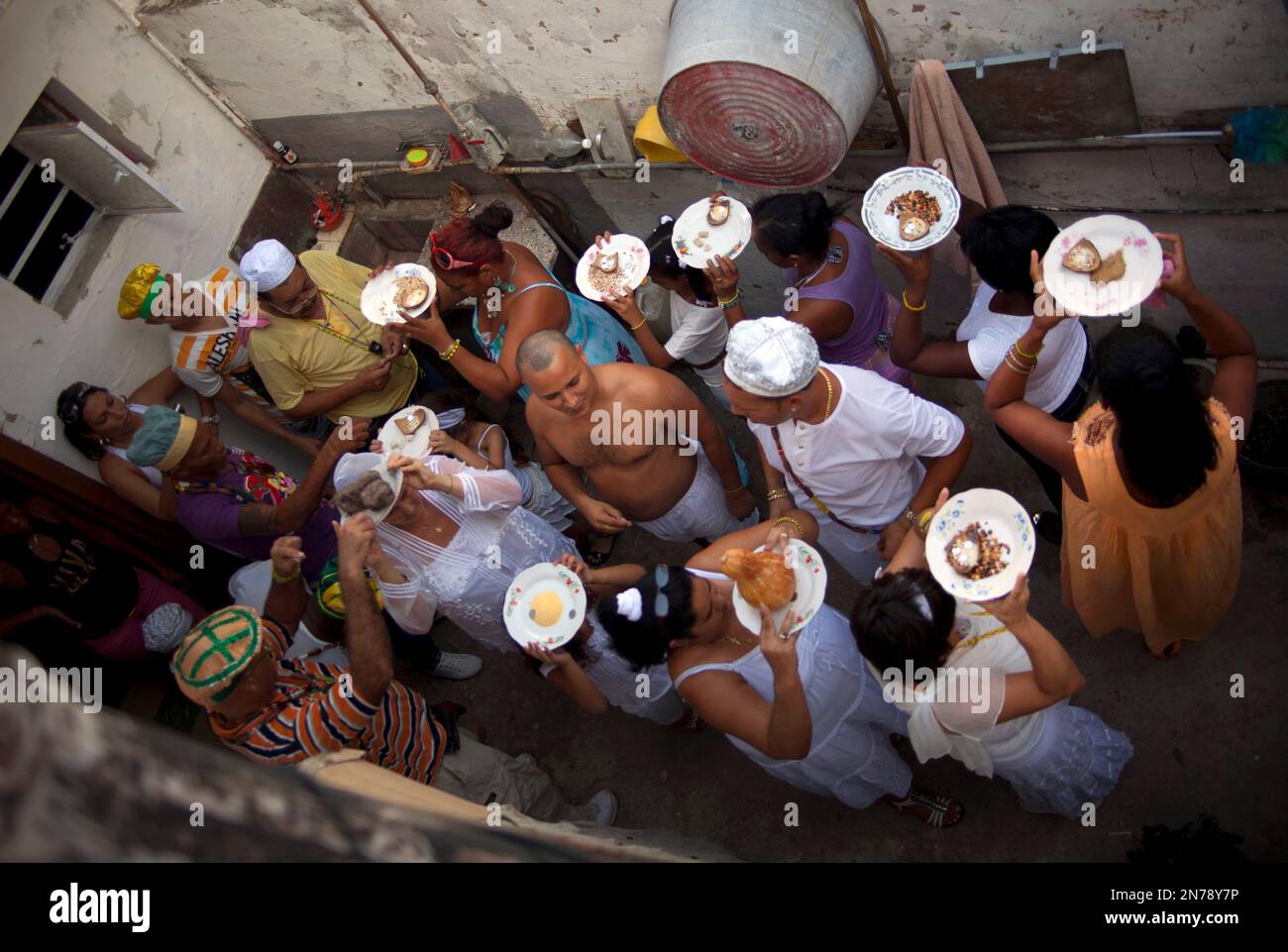 Cuban Santeria priests, also known as Babalawos, and relatives offer ...