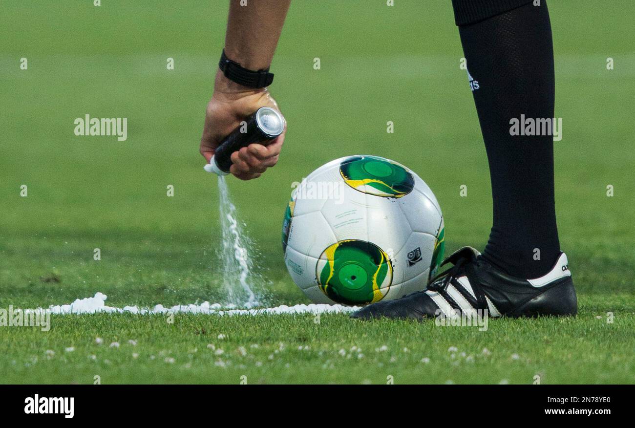 Referee Peter O Leary from New Zealand uses vanishing spray to mark the ...