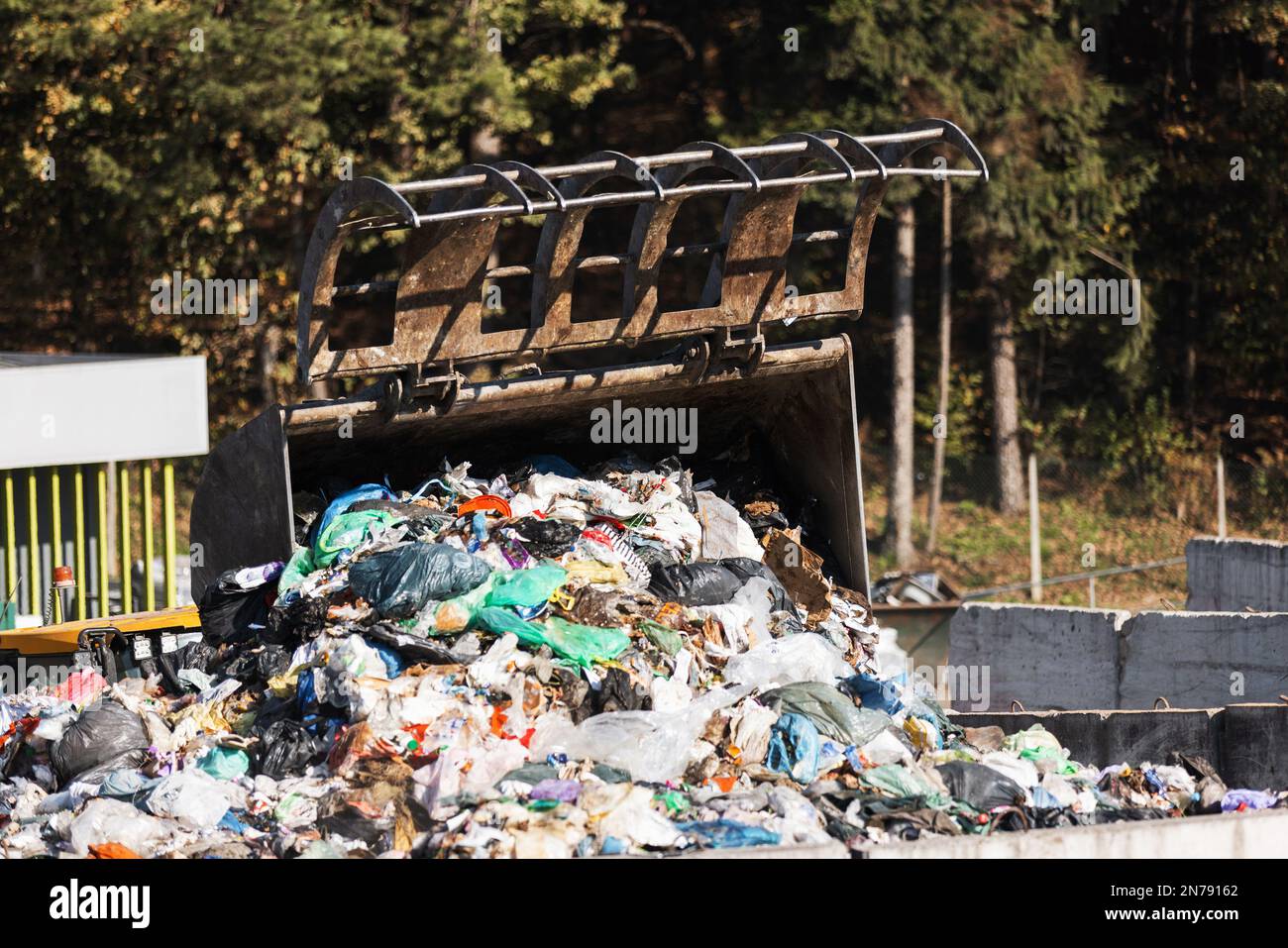 Skid steer loader moving garbage at the landfill site, before ...