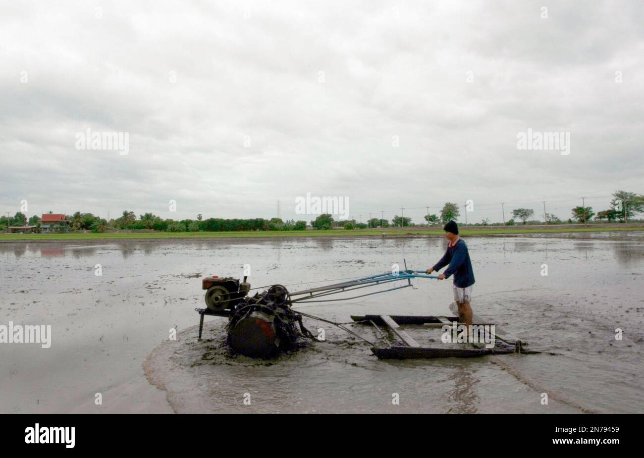 A Thai farmer plows his rice field in Ayutthaya province, central ...
