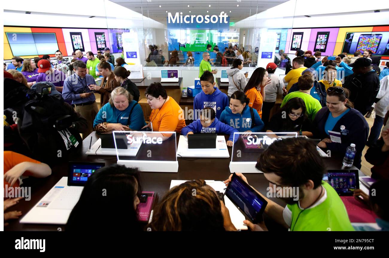 People crowd the aisles during the grand opening of a Microsoft retail ...