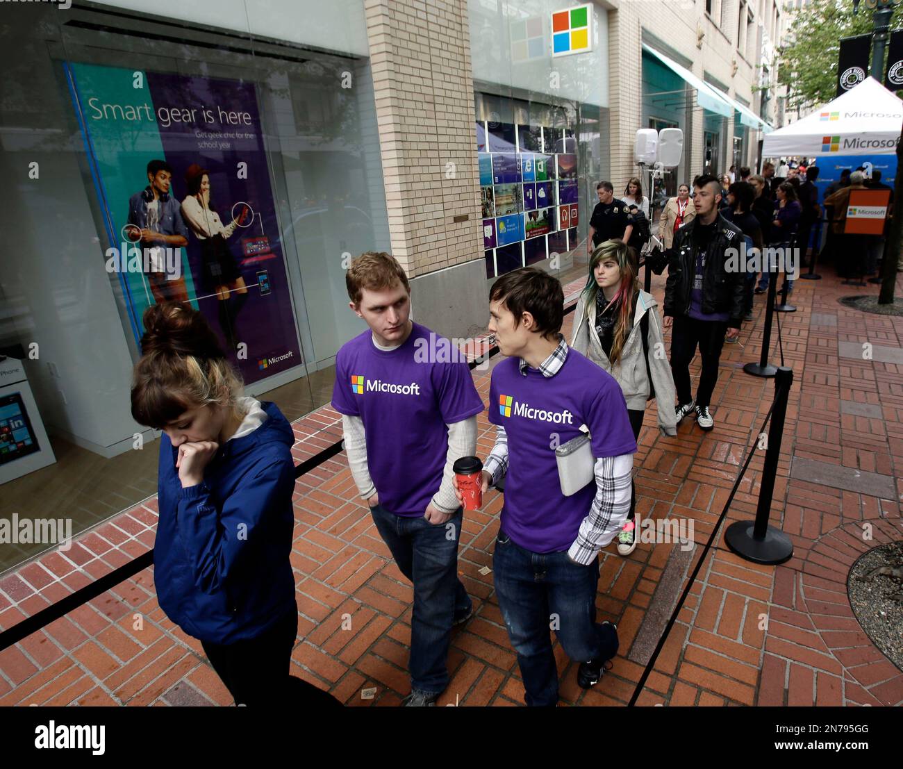 People line up outside during the grand opening of a Microsoft retail ...