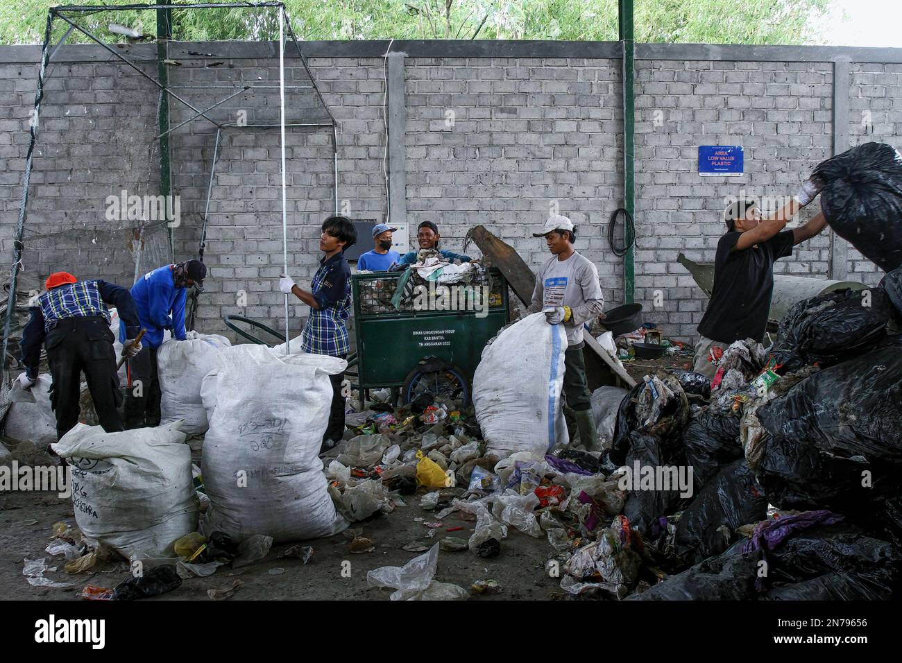 Workers sort waste at a waste management site in Panggungharjo. The ...