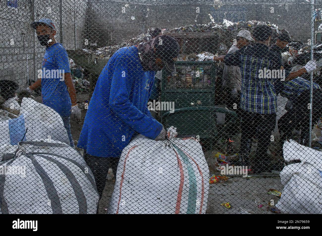 Workers sort waste at a waste management site in Panggungharjo. The ...