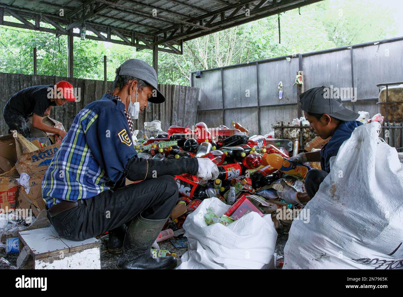 Workers sort waste at a waste management site in Panggungharjo. The ...