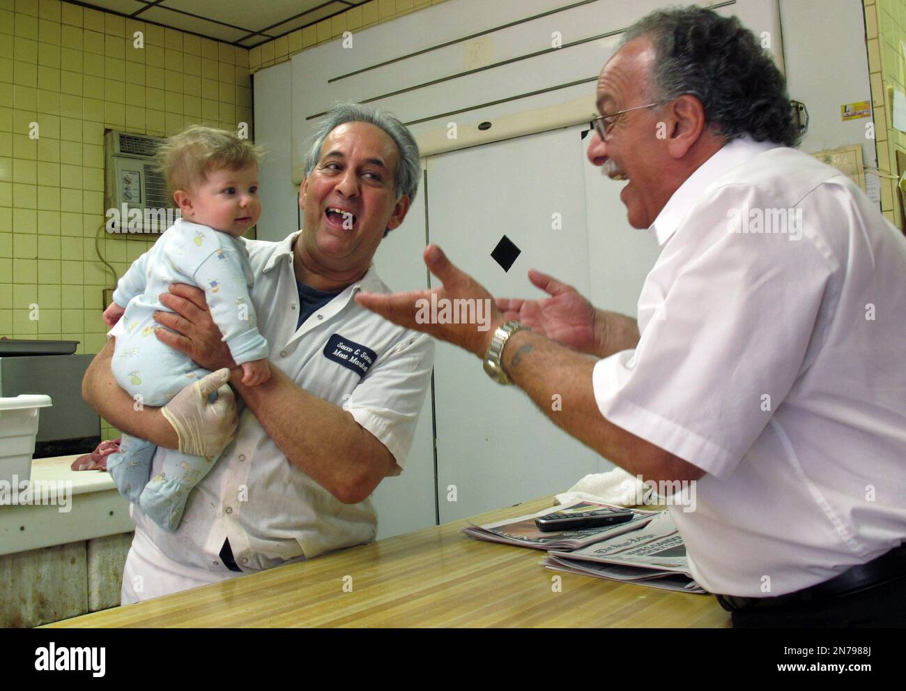 John Sacco Sr. hands his 6-month-old grandson, Jack Russo, to Pete Canu ...