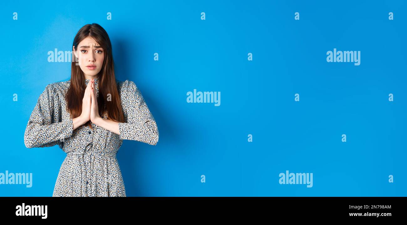 Sad girl asking for help, begging you with troubled face expression ...