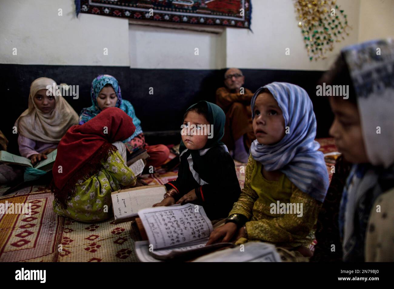 Pakistani girls attend a daily lesson on how to read verses of the ...