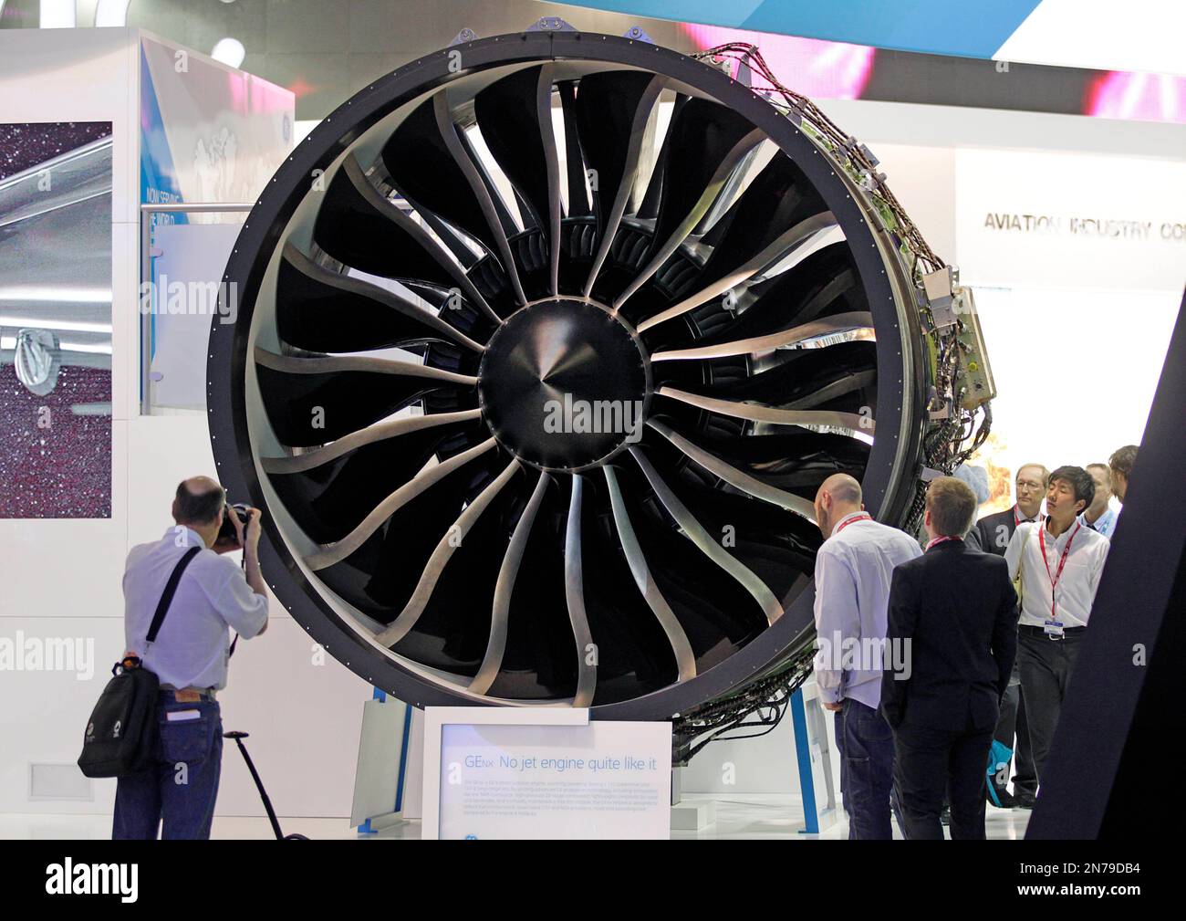 Visitors watch General Electric's turbo fan "the GEnx engine, powering ...