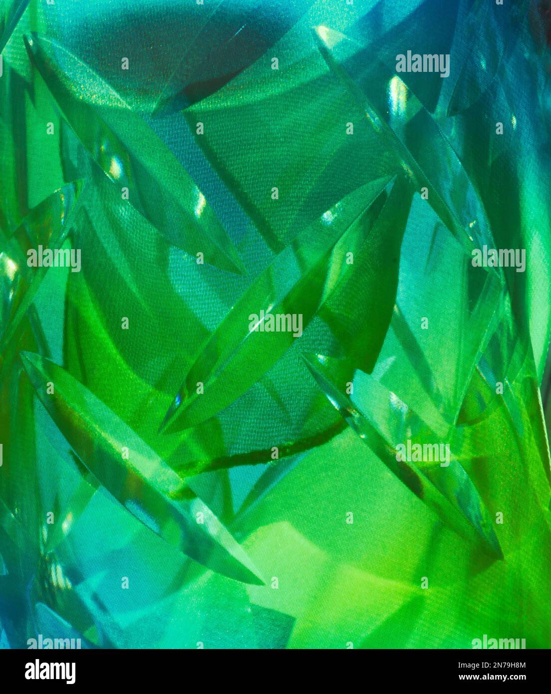 Green, yellow, blue tone abstract background with backlit fabric shows ...