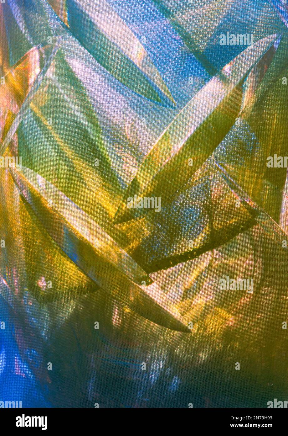 Green, yellow, blue tone abstract background with backlit fabric shows ...