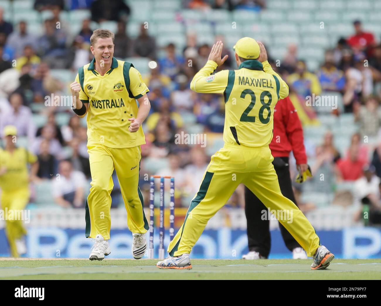 Australia's Xavier Doherty, left, celebrates after taking the wicket of ...
