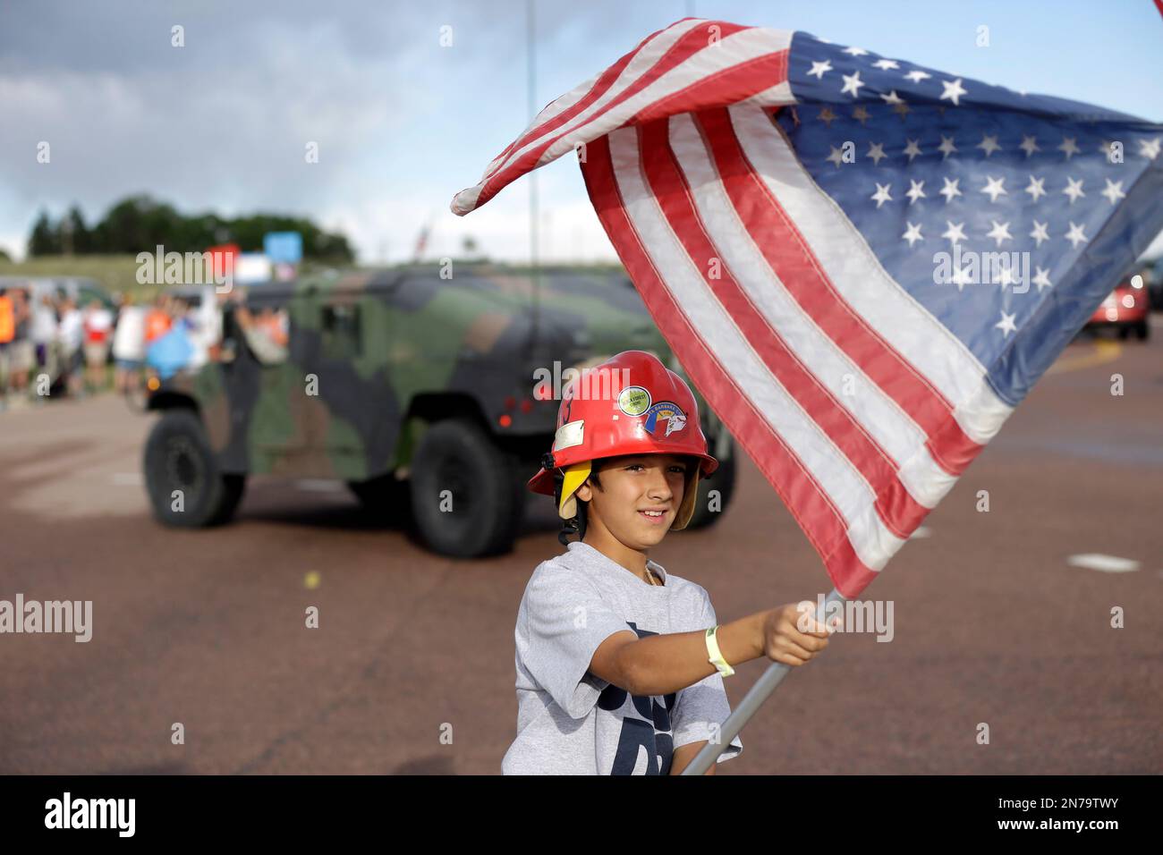 Landon Epperson, 10, waves a Unite States flag while wearing a ...