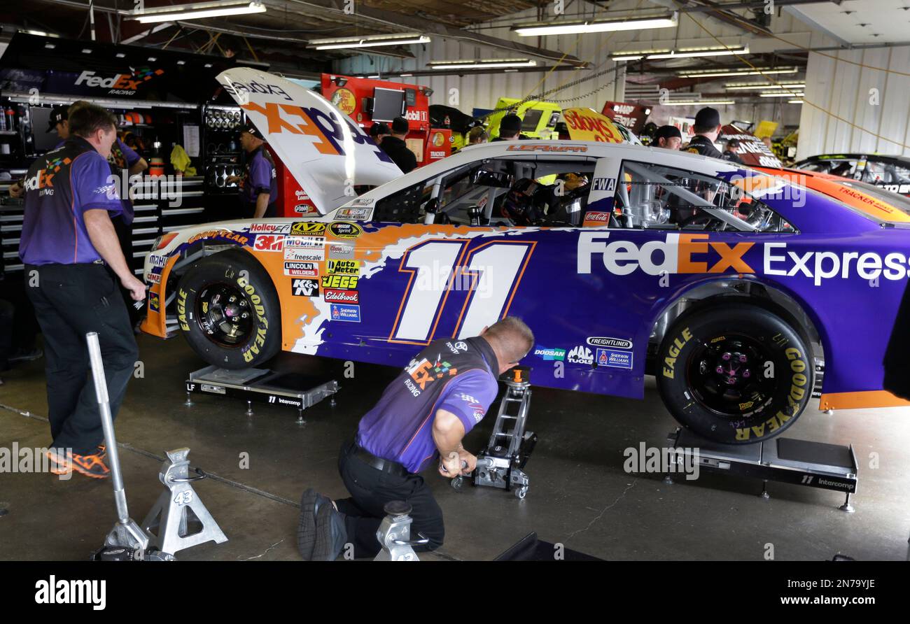 Sprint Cup Series driver Denny Hamlin's crew work on his car before the ...