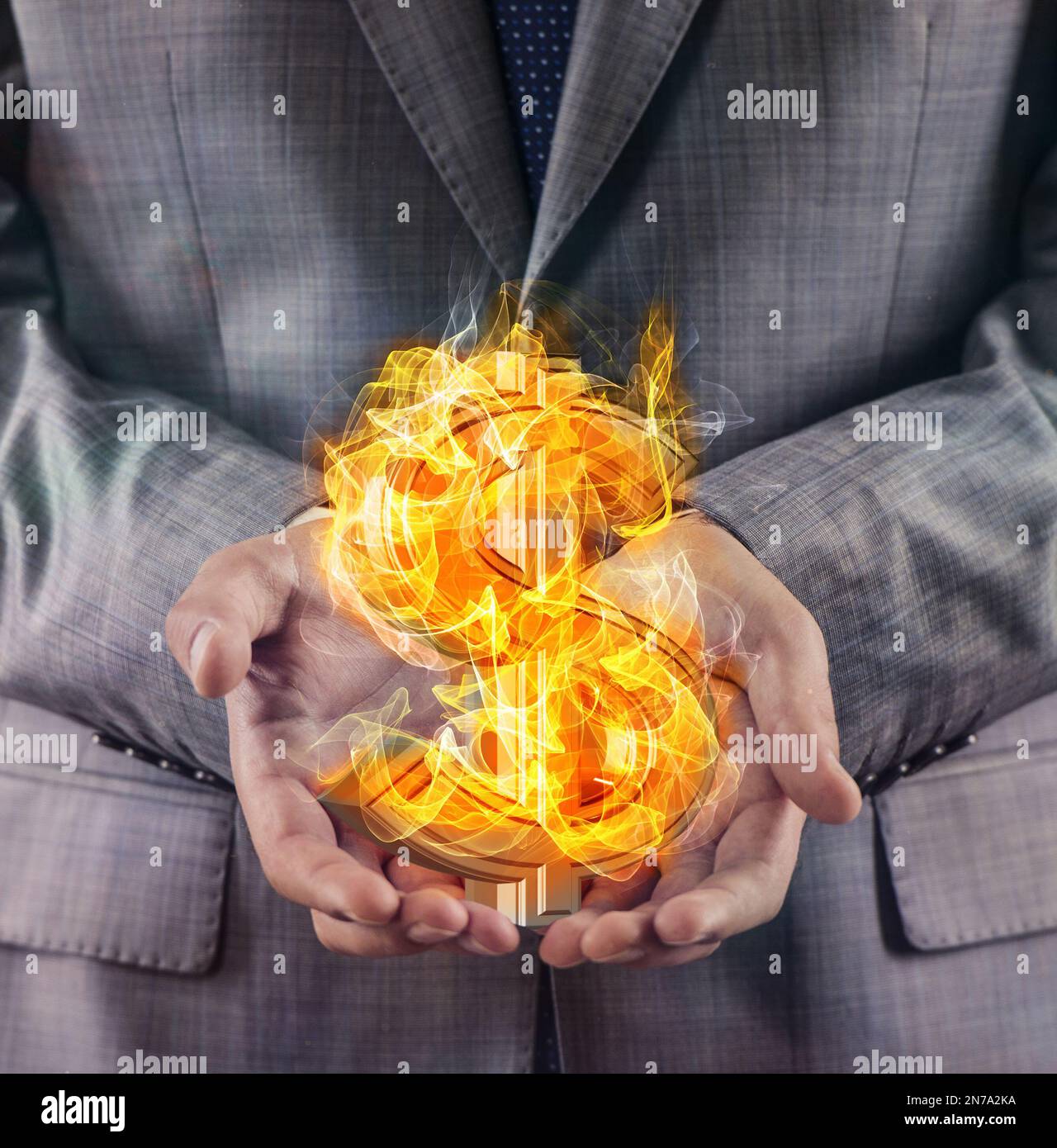 The businessman holding burning american dollar sign Stock Photo - Alamy