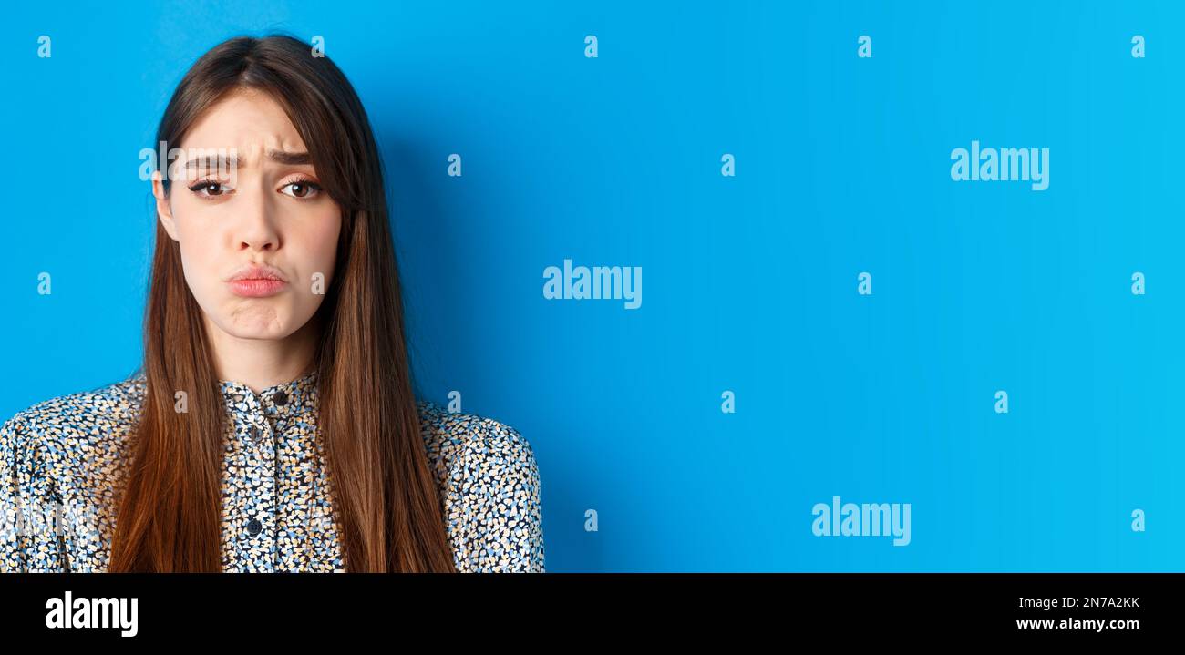 People emotions concept. Sad cute girl begging for something, pucker ...