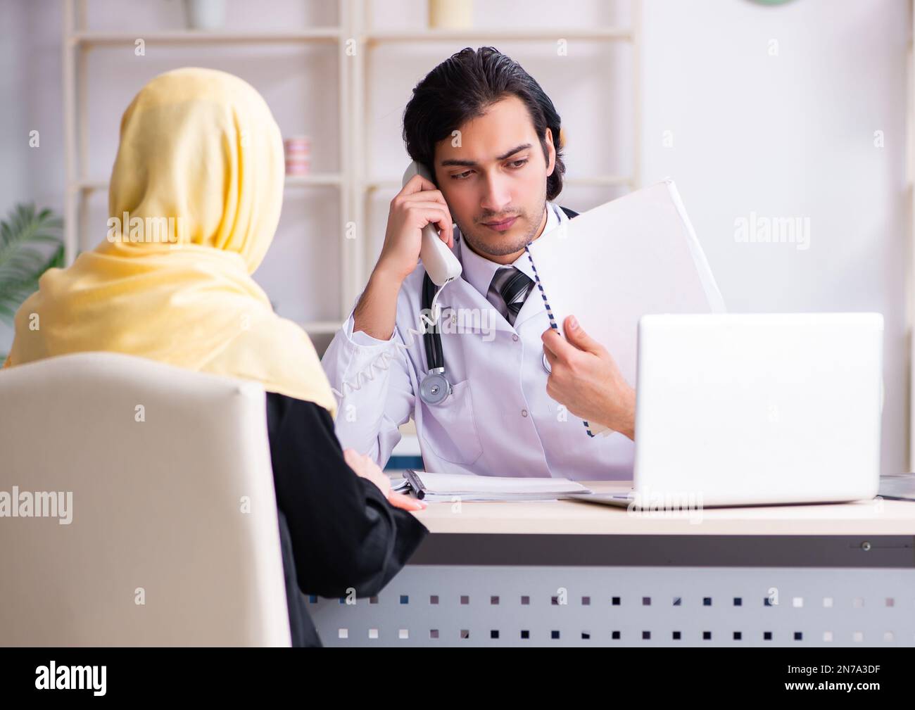 The female arab patient visiting male doctor Stock Photo - Alamy