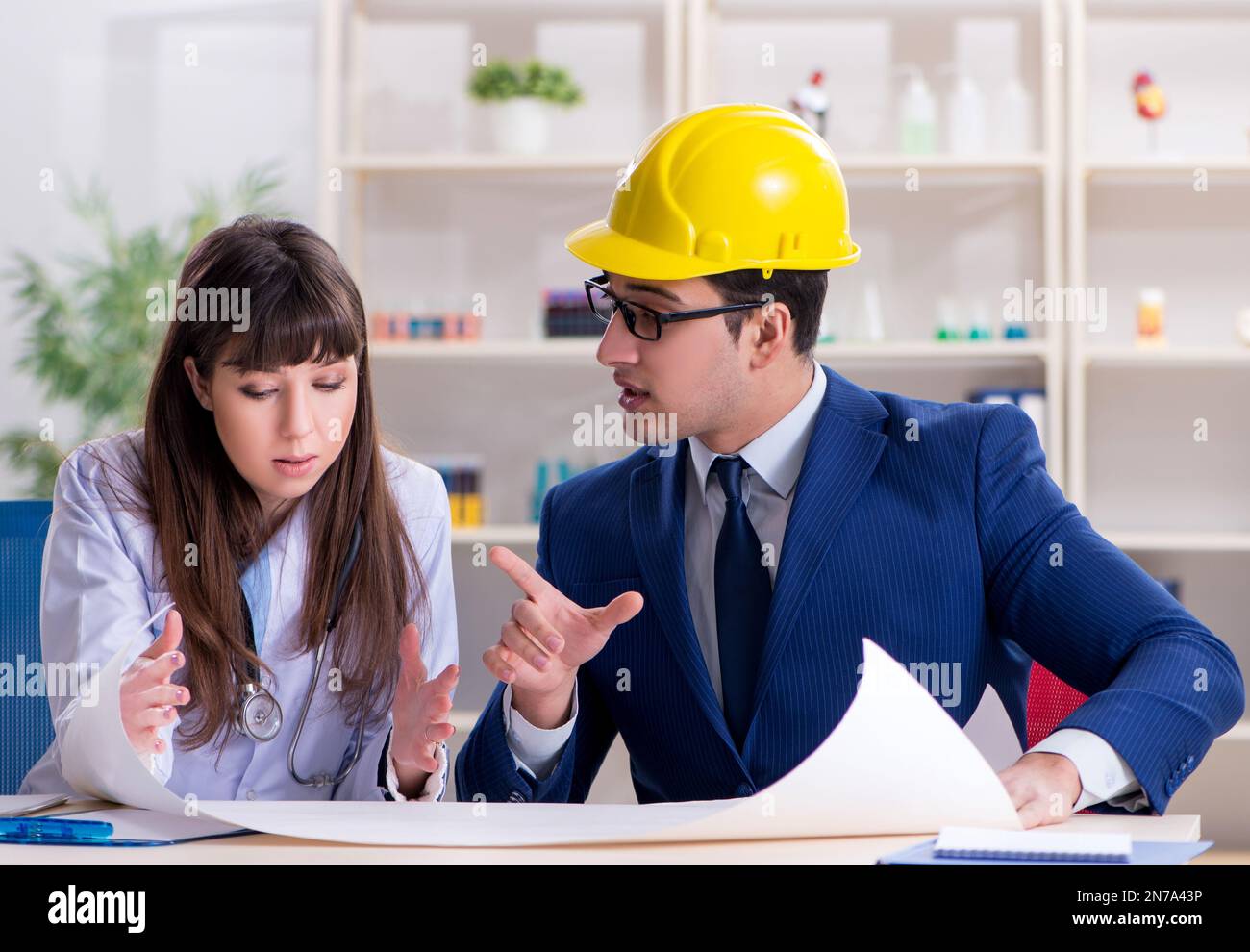 The doctor discussing new hospital plan with architect Stock Photo - Alamy