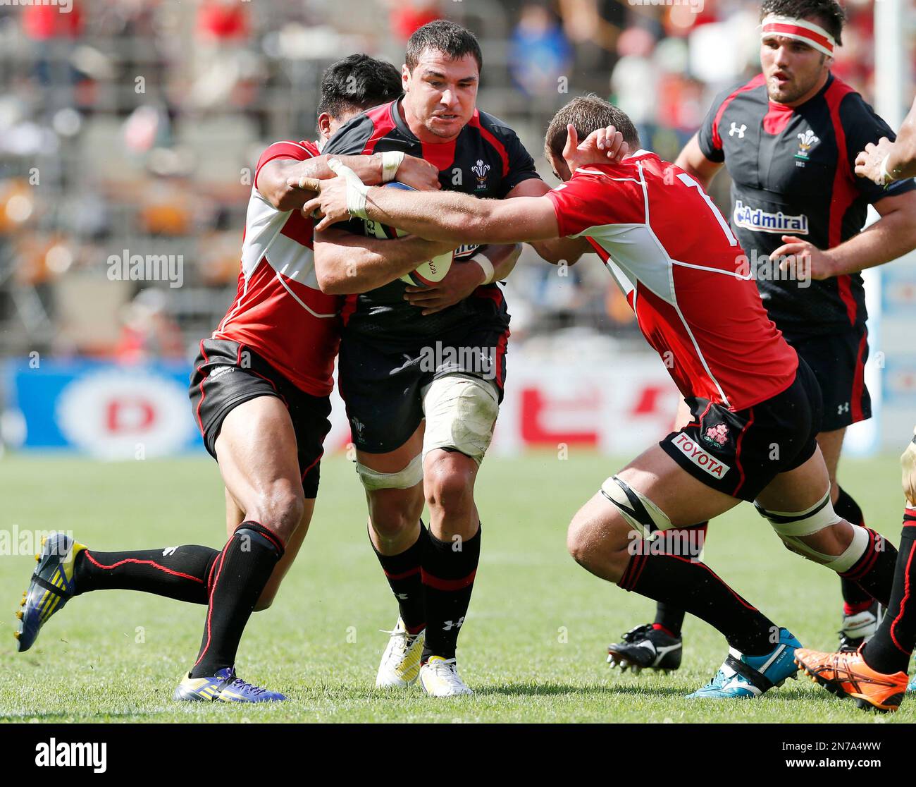 Wale's Andries Pretorius, center is tackled by Japan's Male Sau, left ...