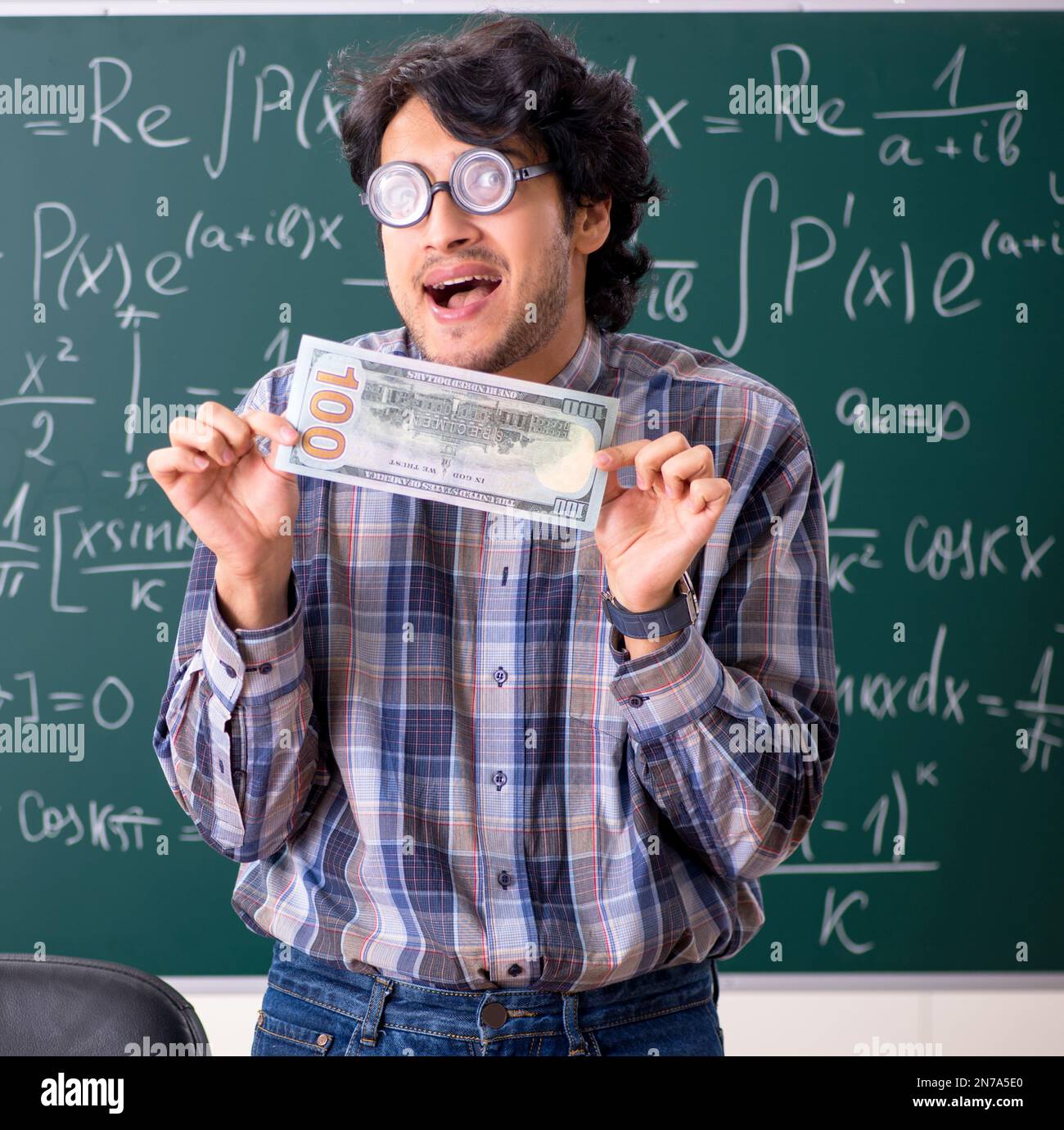 The funny male math teacher in the classroom Stock Photo - Alamy