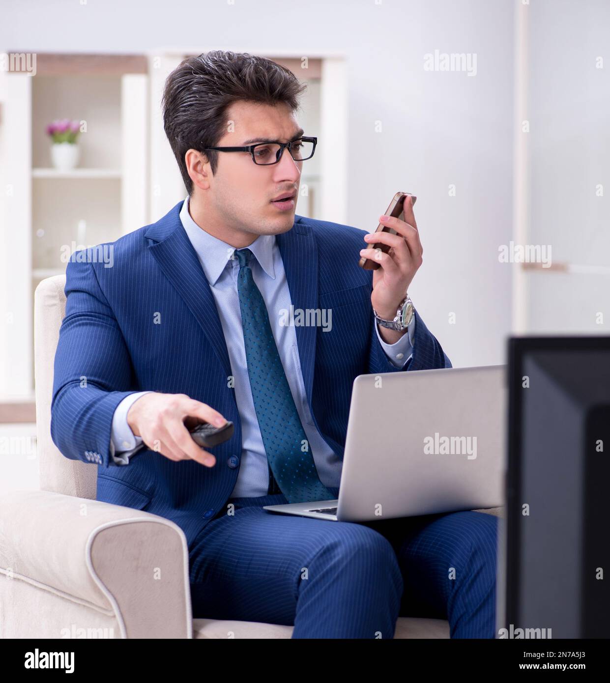 The businessman watching tv in the office Stock Photo - Alamy