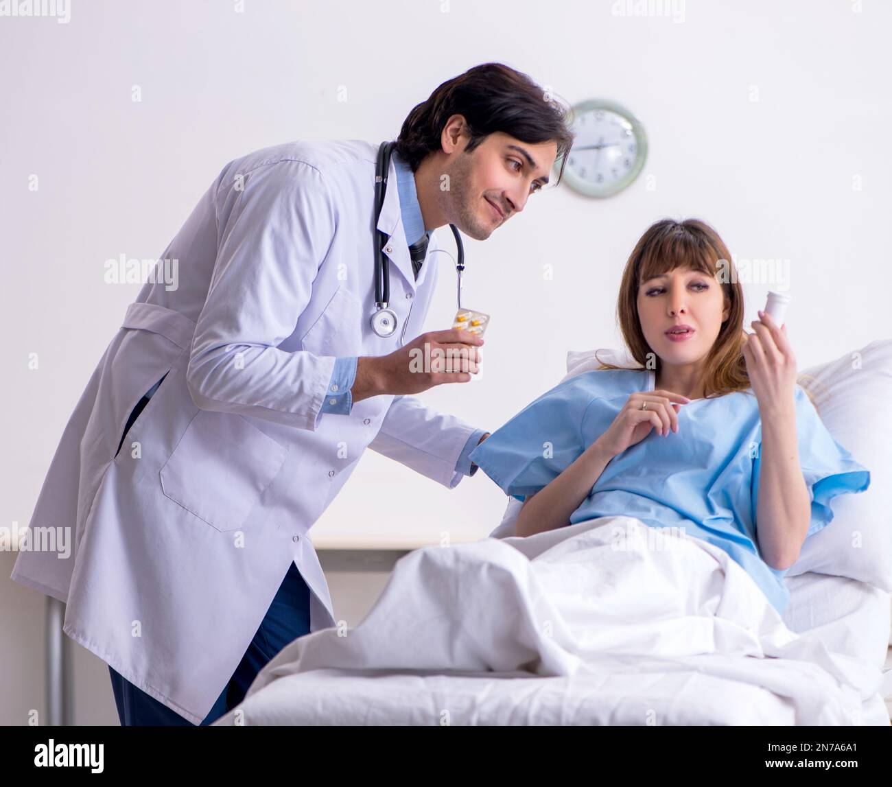 The male doctor visiting female patient in ward Stock Photo - Alamy