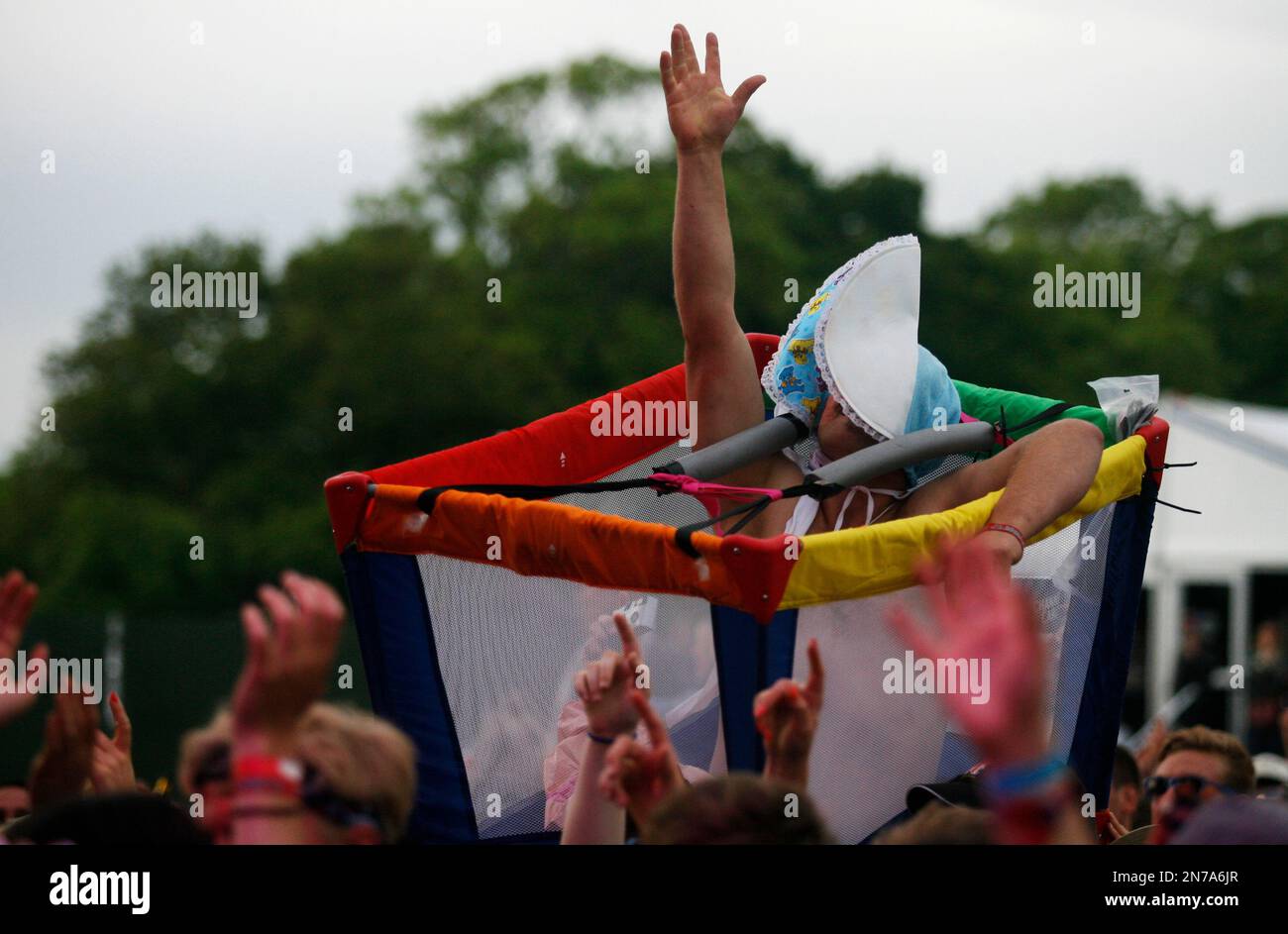 A festival goer crowd surfers in fancy dress at Isle of Wight Festival ...