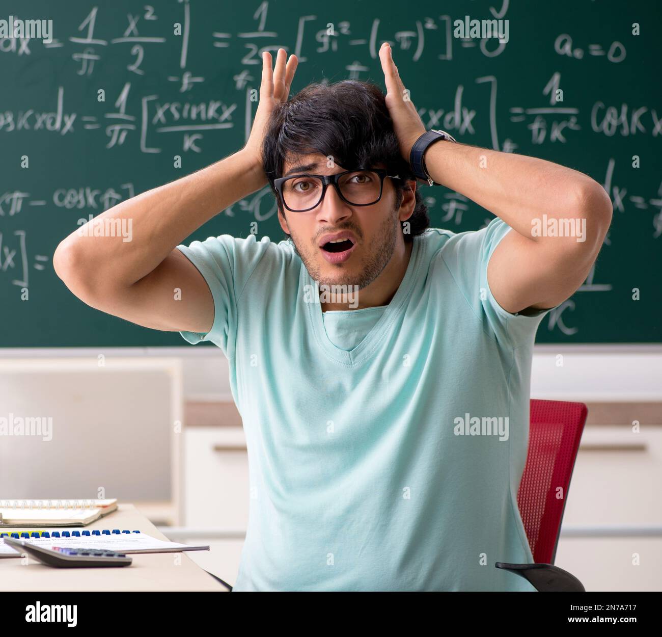 The young male student mathematician in front of chalkboard Stock Photo ...