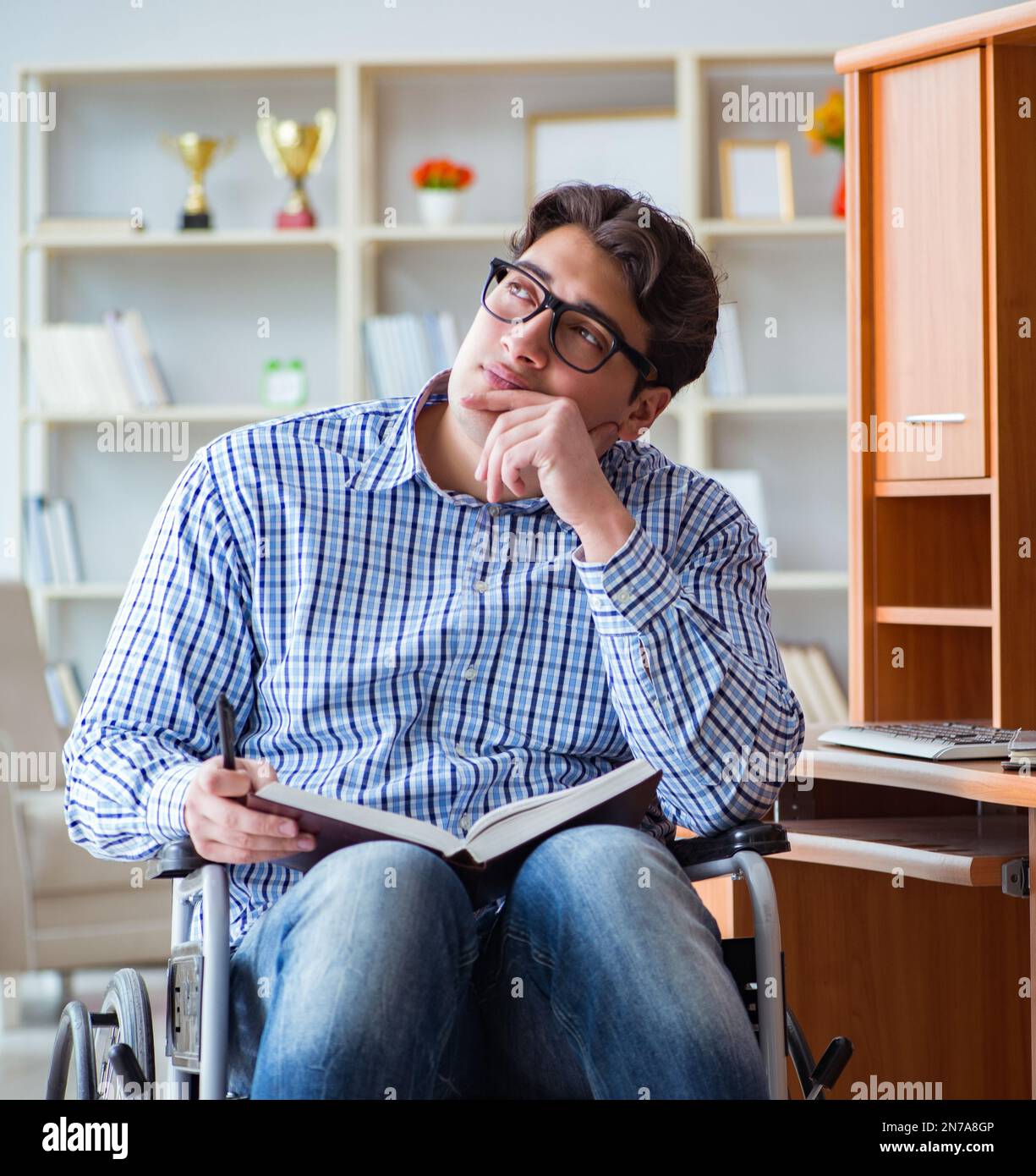 The disabled student studying at home on wheelchair Stock Photo - Alamy