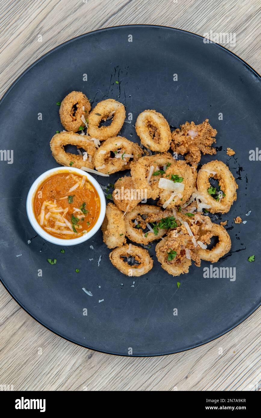 Overhead view of tempting appetizer of breaded calamari rings with ...