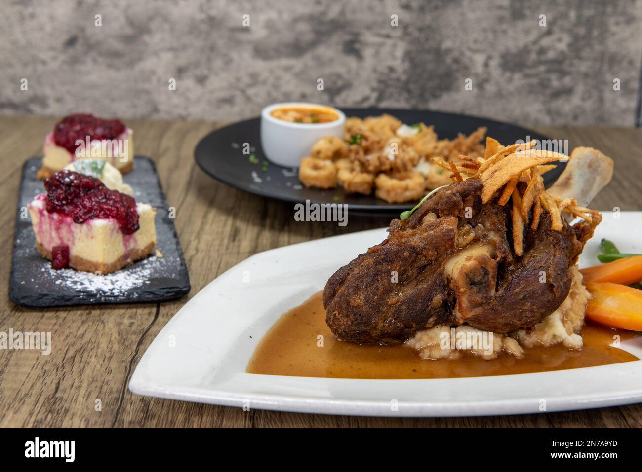 Full feast of the table with the roasted lamb shank featured up front ...