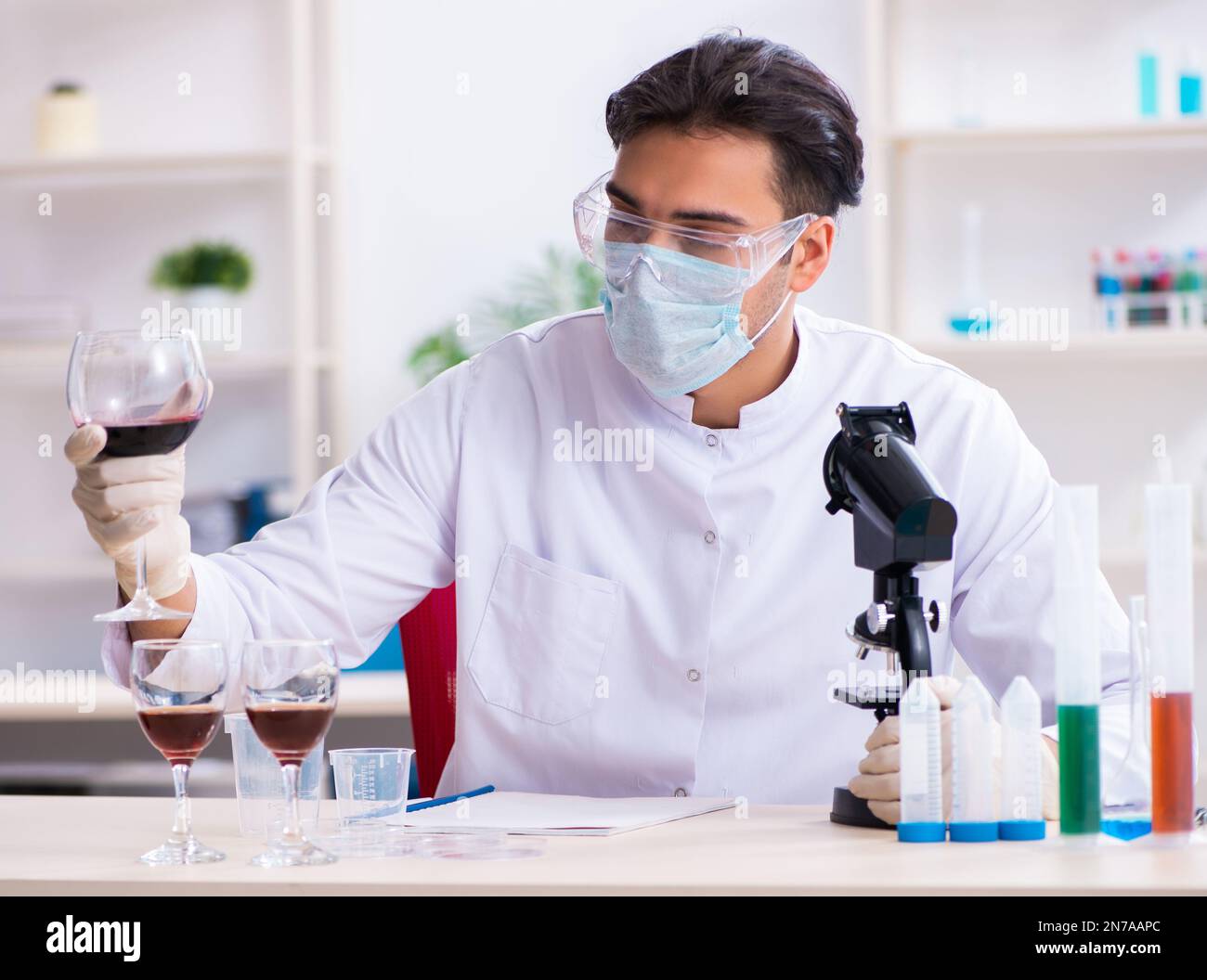 The male chemist examining wine samples at lab Stock Photo - Alamy
