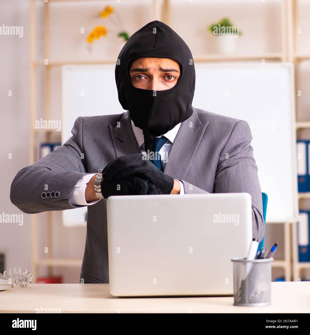 The male gangster stealing information from the office Stock Photo - Alamy