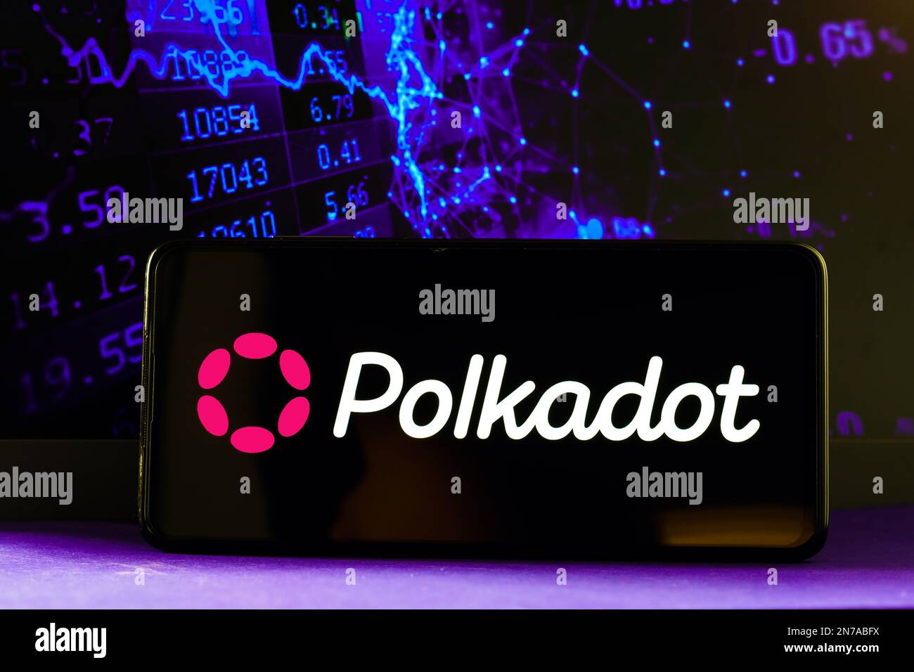 In this photo illustration the Polkadot logo seen displayed on a ...