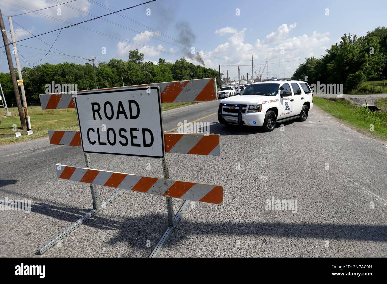 State police man a roadblock as smoke burn off from a flare at a ...