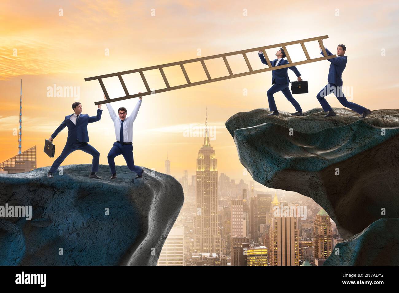 Business people helping to go over the chasm Stock Photo - Alamy
