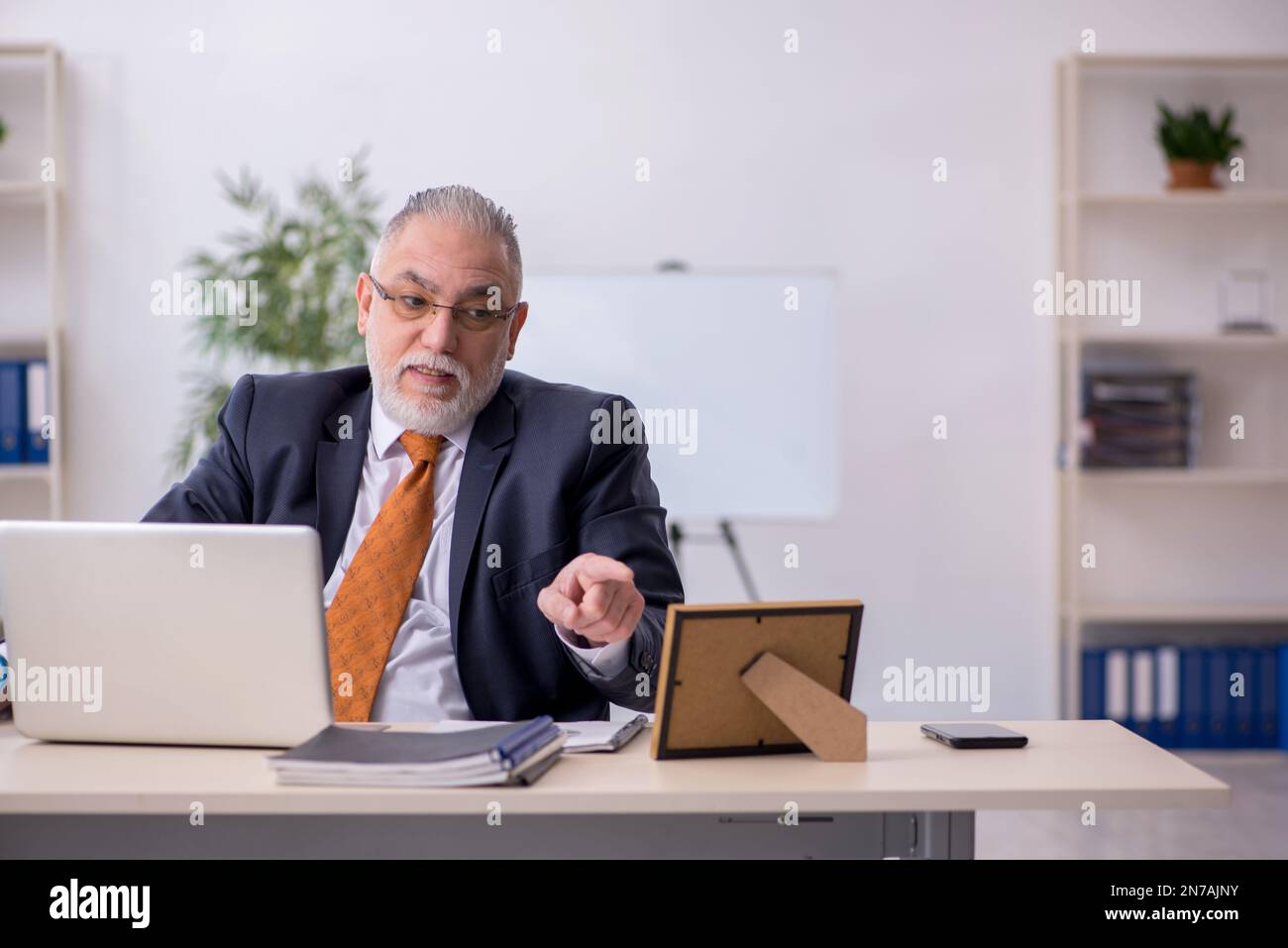 Old businessman employee missing his wife at workplace Stock Photo - Alamy