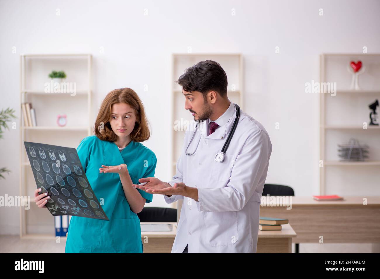 Young male doctor radiologist and female assistant working at the ...