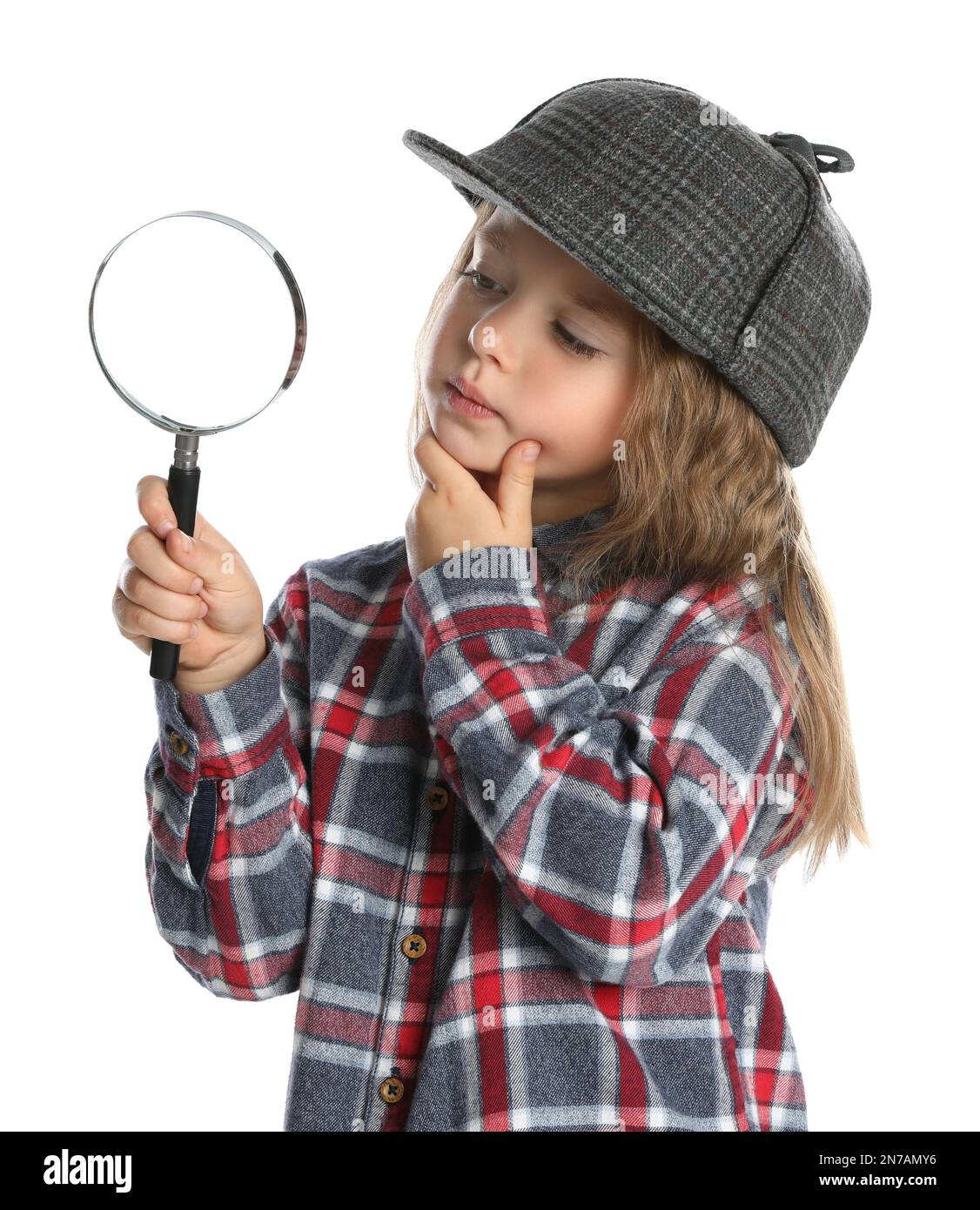 Cute little child in hat with magnifying glass playing detective on ...