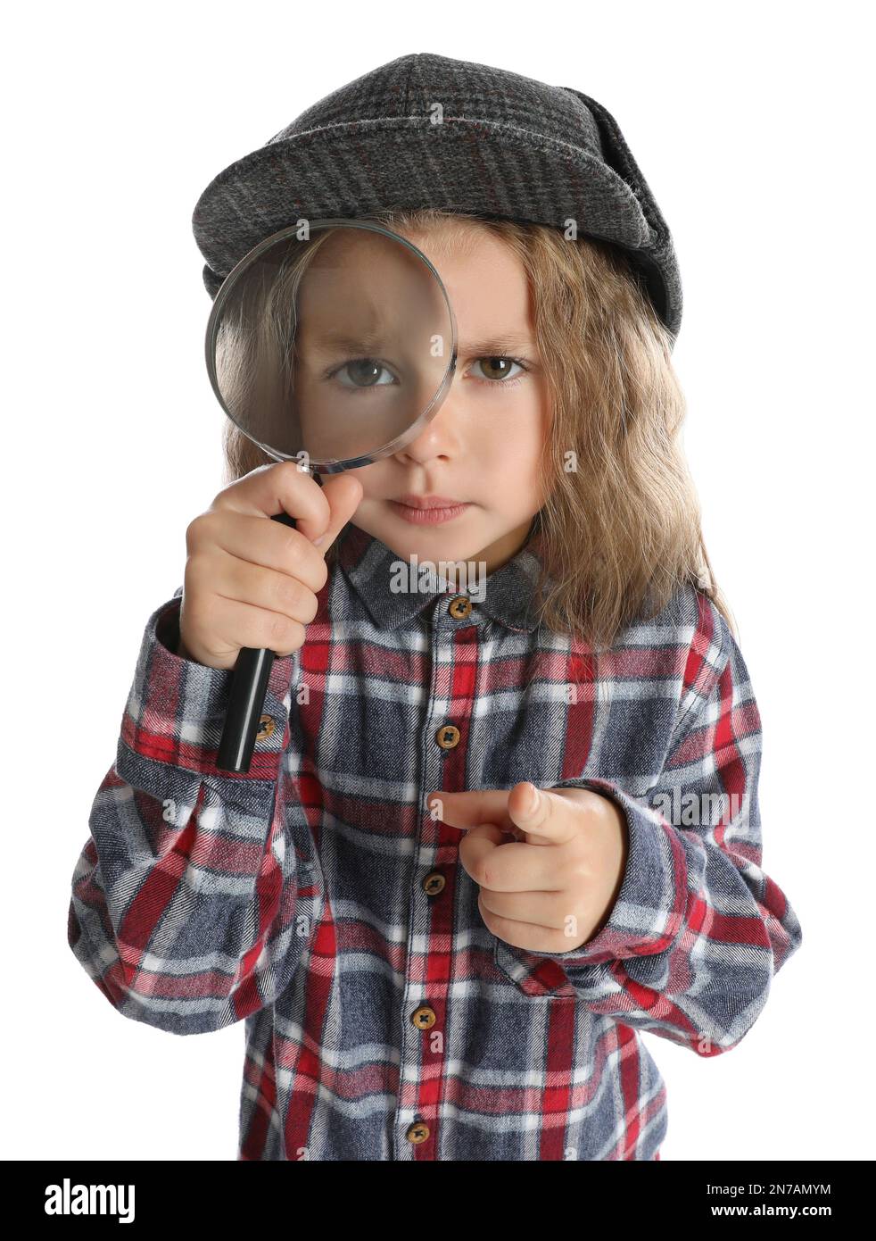 Cute little child in hat with magnifying glass playing detective on ...