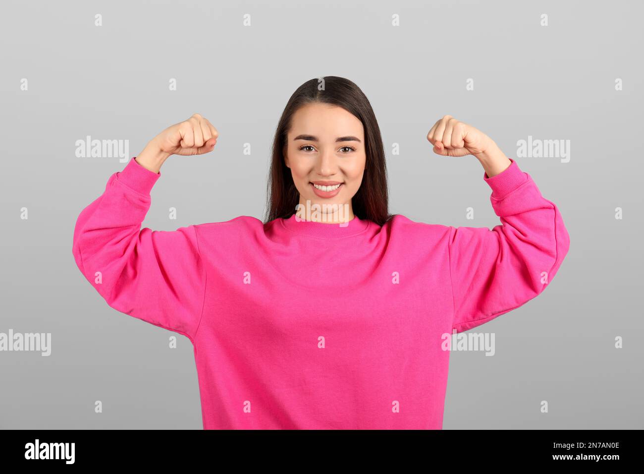 Strong woman as symbol of girl power on light grey background. 8 March ...