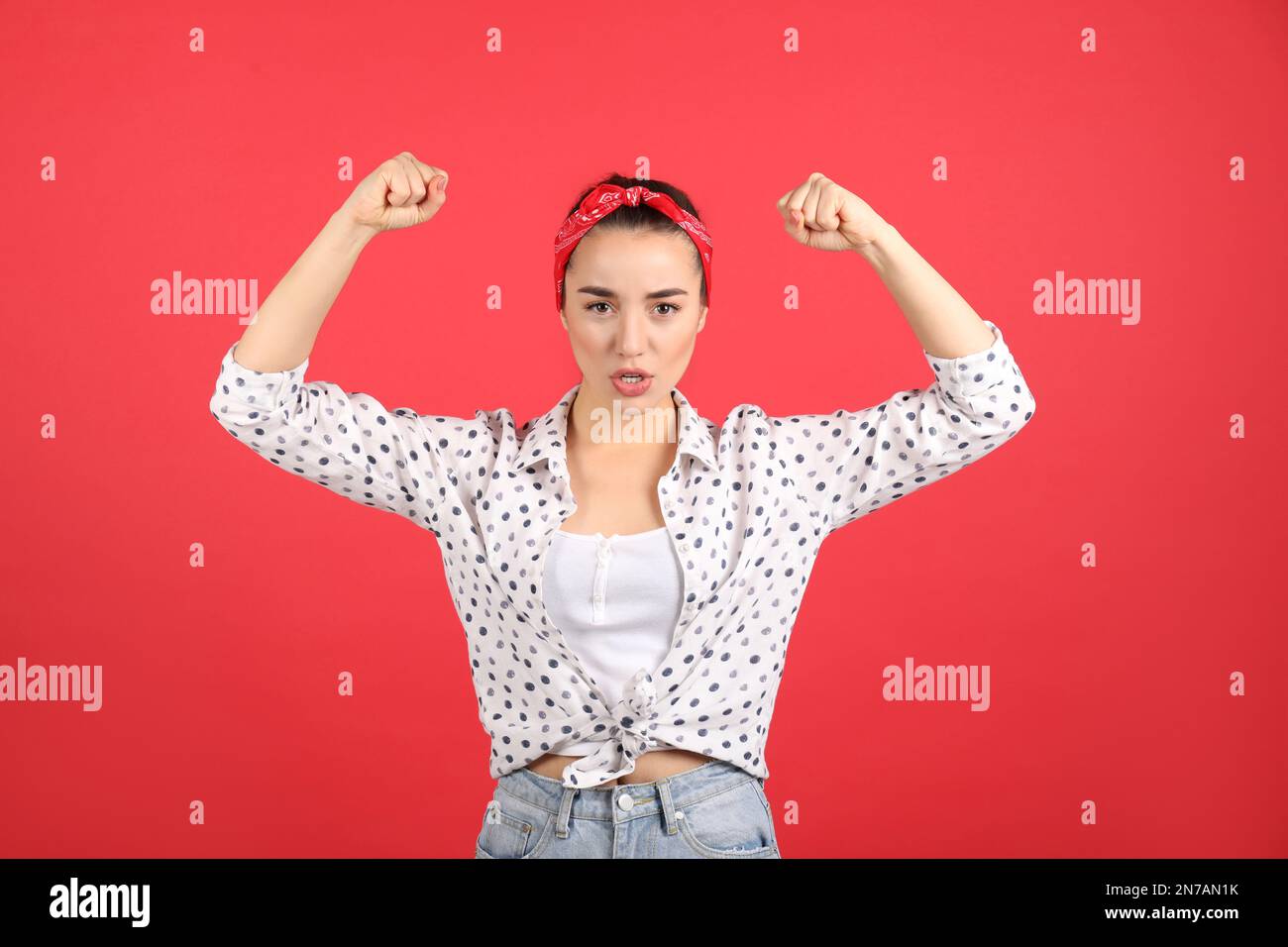 Strong woman as symbol of girl power on red background. 8 March concept ...